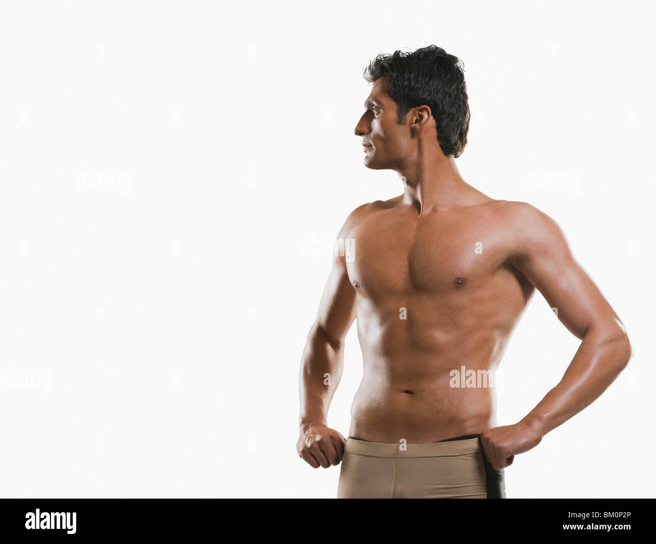 Man standing with arms akimbo Stock Photo - Alamy
