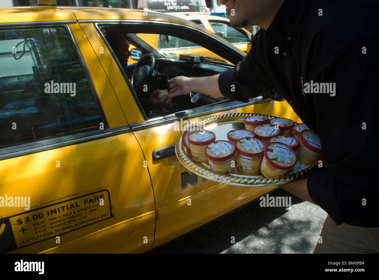 Employees of Håågen-Dazs ice cream distribute free samples outside a ...