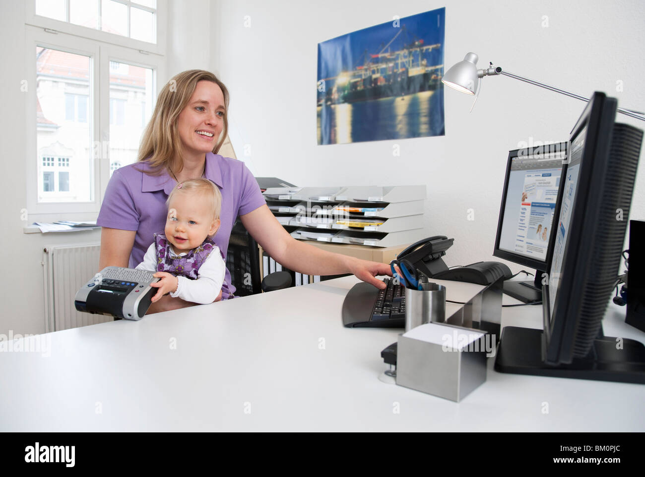 Businesswoman and baby in office Stock Photo - Alamy