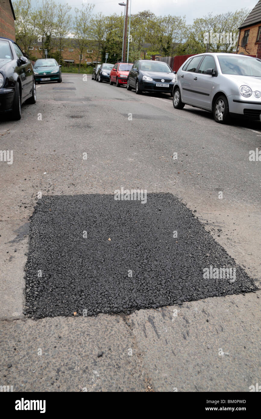 Repaired pot hole in a suburban road in Hounslow, Middx, UK. May 2010 ...