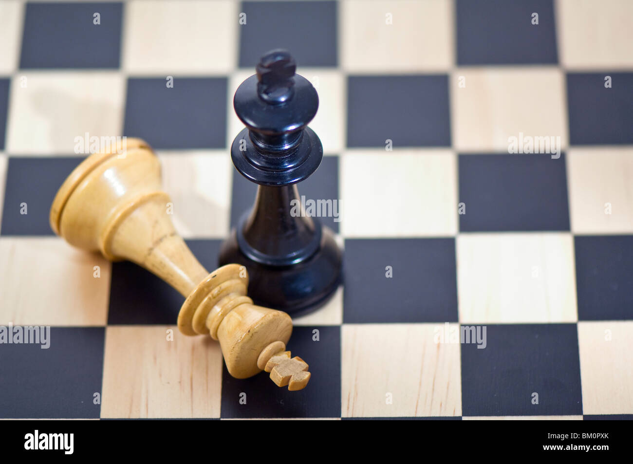 Chess. Black King victorious on chess board Stock Photo - Alamy