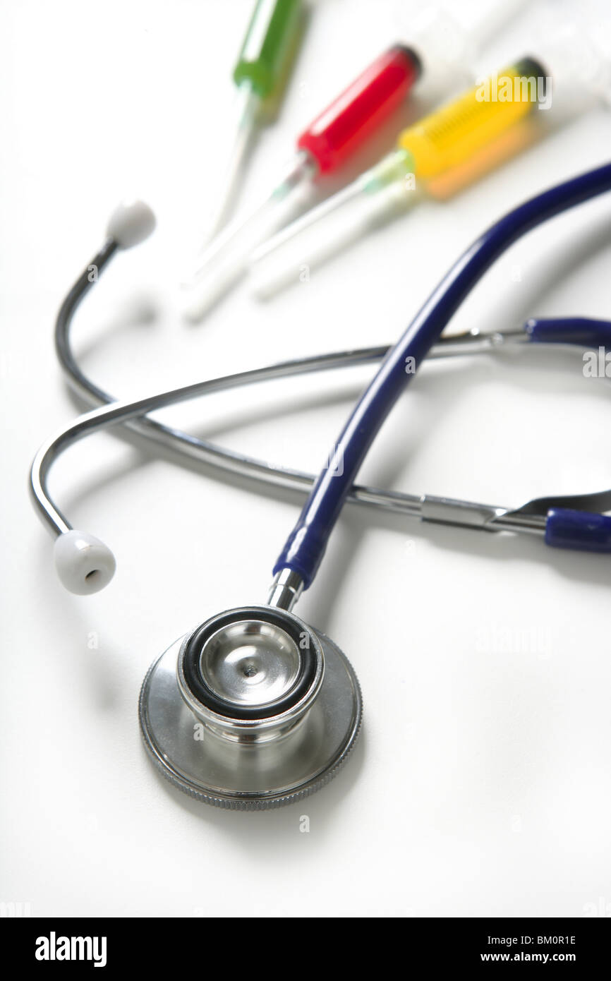 Medical still photo with blue stethoscope and colorful syringe over ...