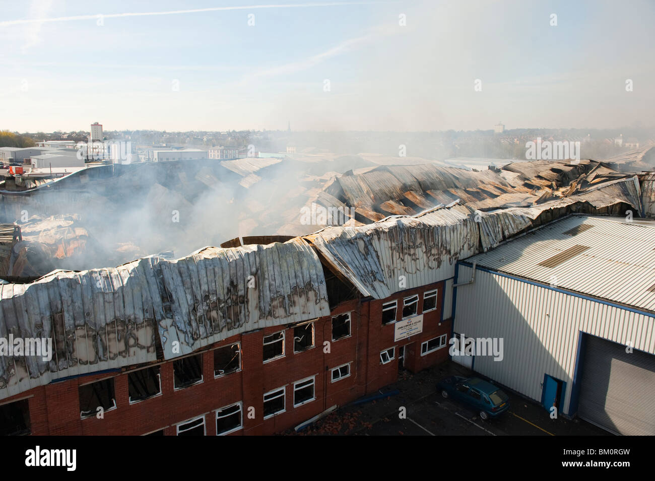 Large factory and warehouse collapsed and smoldering following major ...