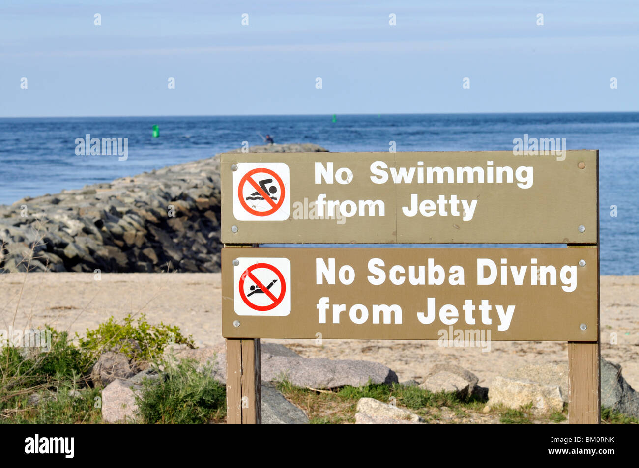 No swimming or scuba diving from jetty signs made of wood at a beach in ...