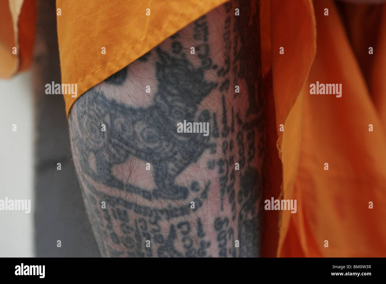 A monk's leg at Wat Bang Phra, a Buddhist temple in Thailand where ...