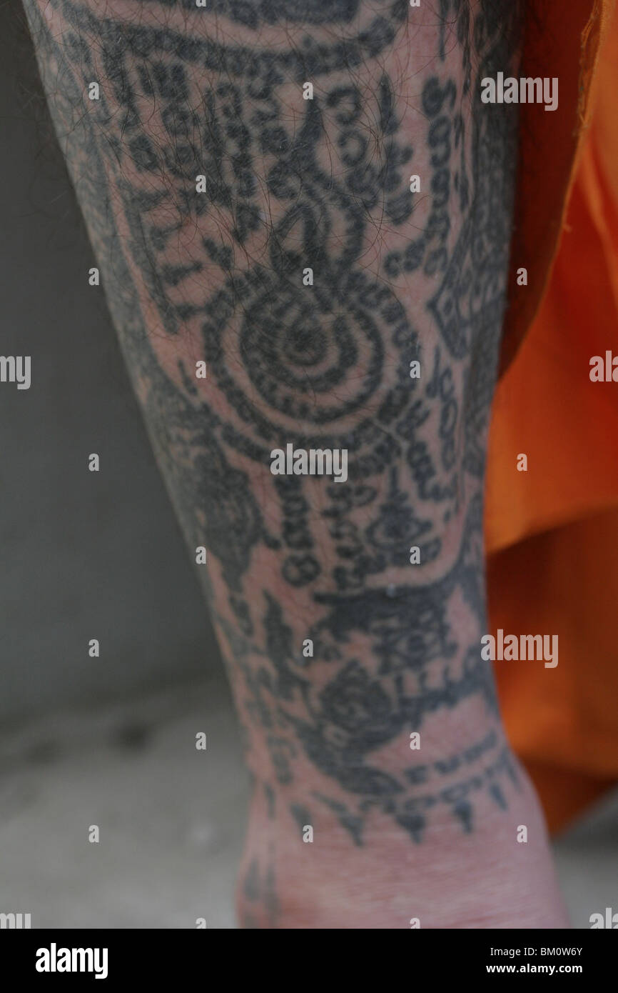 A monk's leg at Wat Bang Phra, a Buddhist temple in Thailand where ...