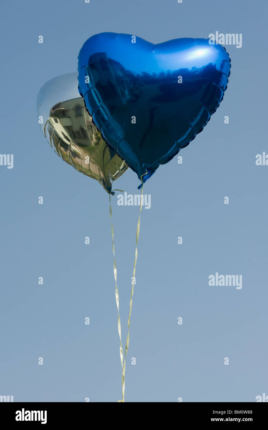 Heart shaped balloons flying in the air Stock Photo - Alamy
