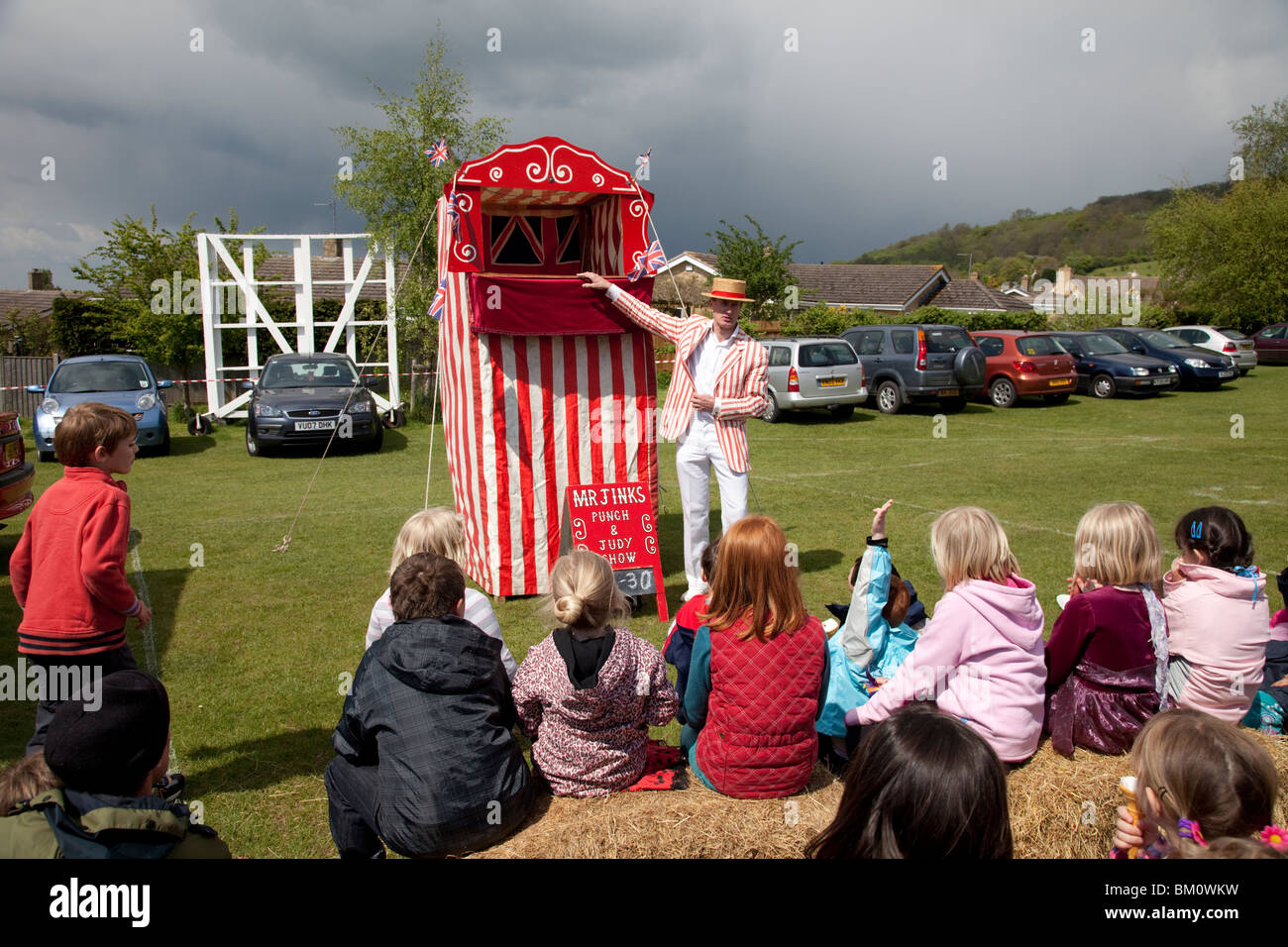 Children watching Punch and Judy show on Mayday at Woodmancote ...
