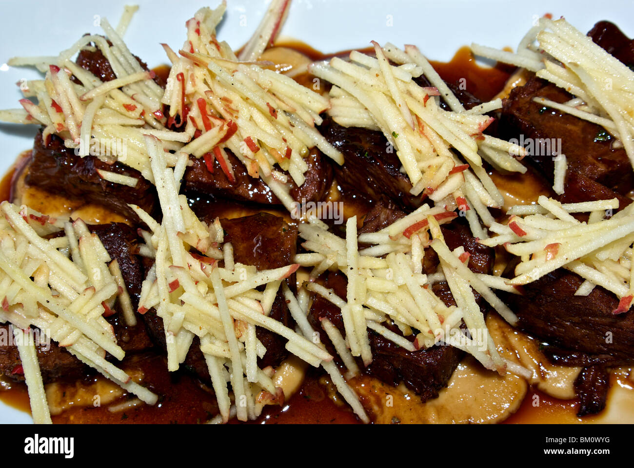 Sharing platter of braised boneless beef short ribs with slivered apple ...