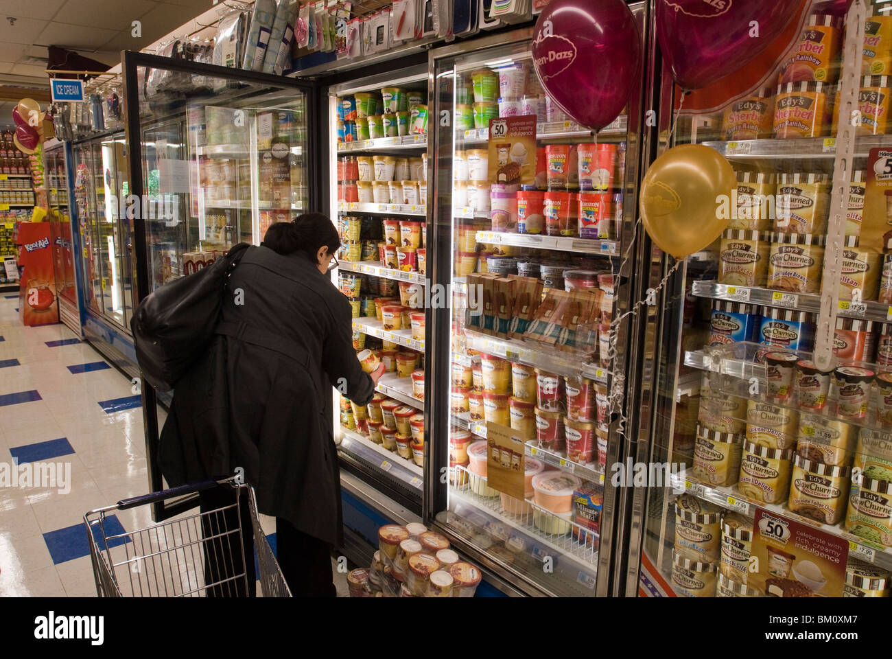 Shoppers browse Håågen-Dazs ice cream in a freezer in a supermarket in ...