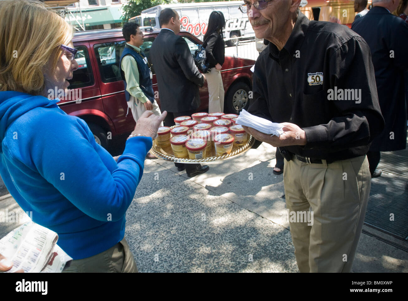 Employees of Håågen-Dazs ice cream distribute free samples outside a ...