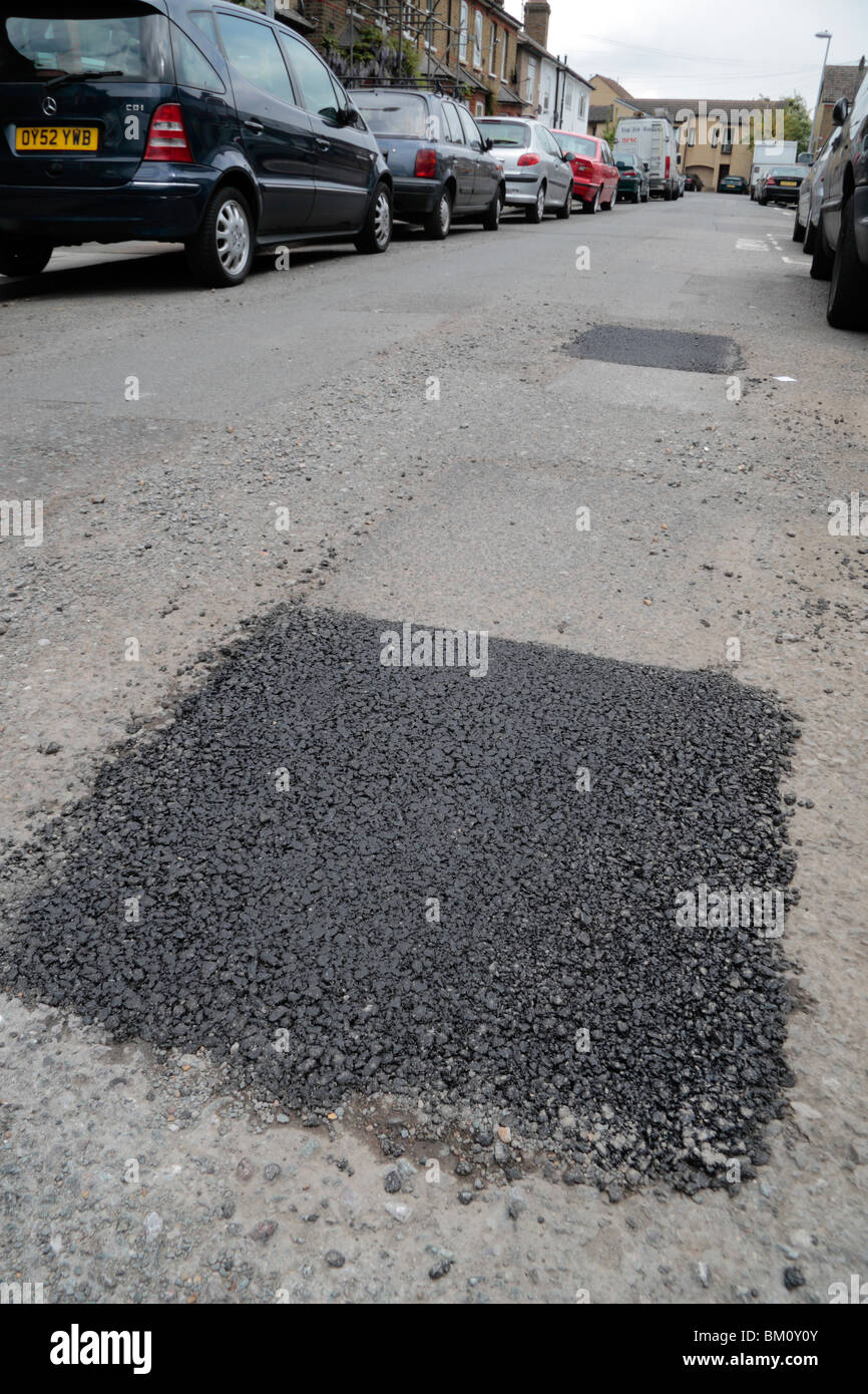 Repaired pot hole in a suburban road in Hounslow, Middx, UK. May 2010 ...