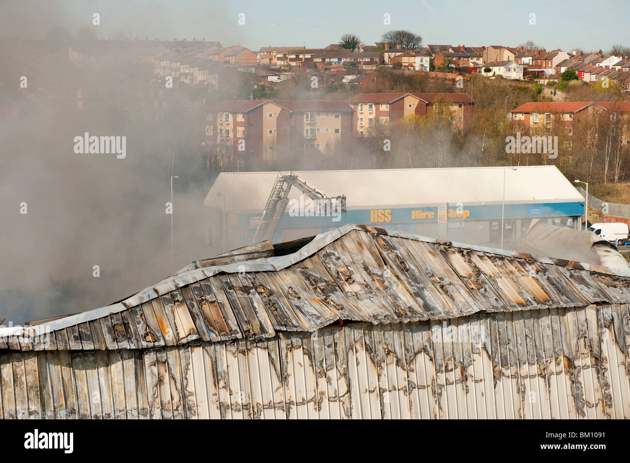 Large factory and warehouse collapsed and smoldering following major ...