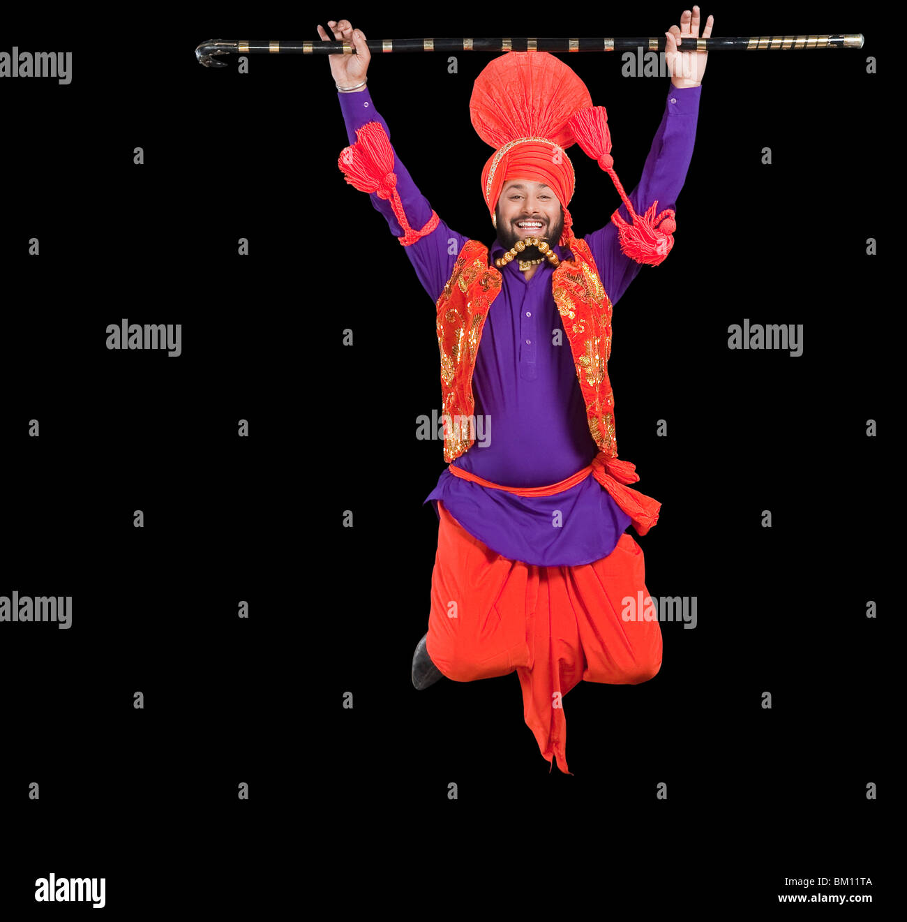 Bhangra dancer holding stick in hi-res stock photography and images - Alamy