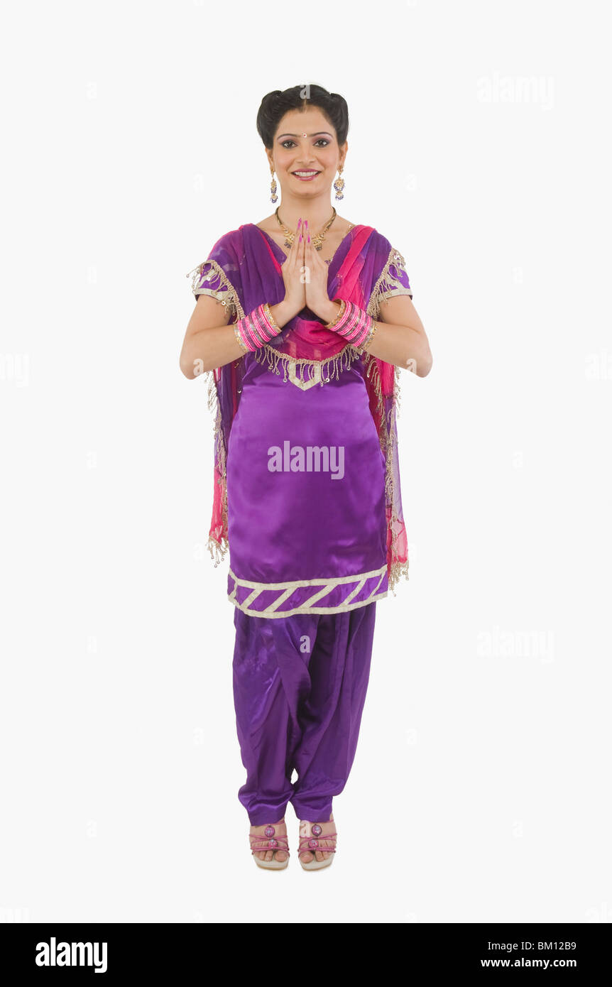 Woman standing in prayer position and smiling Stock Photo - Alamy