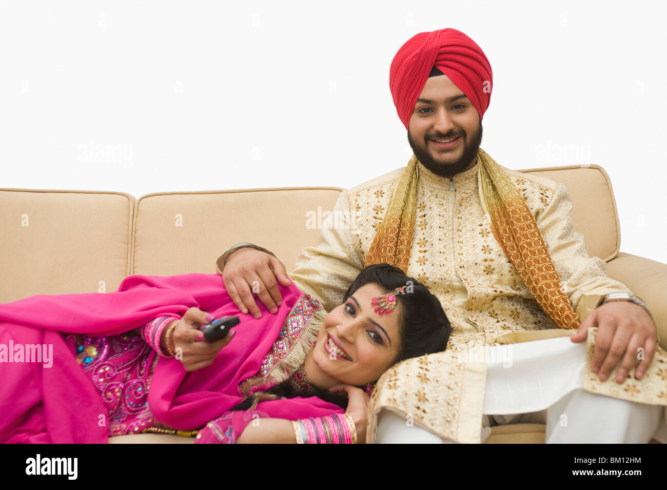 Sikh couple on a couch Stock Photo - Alamy