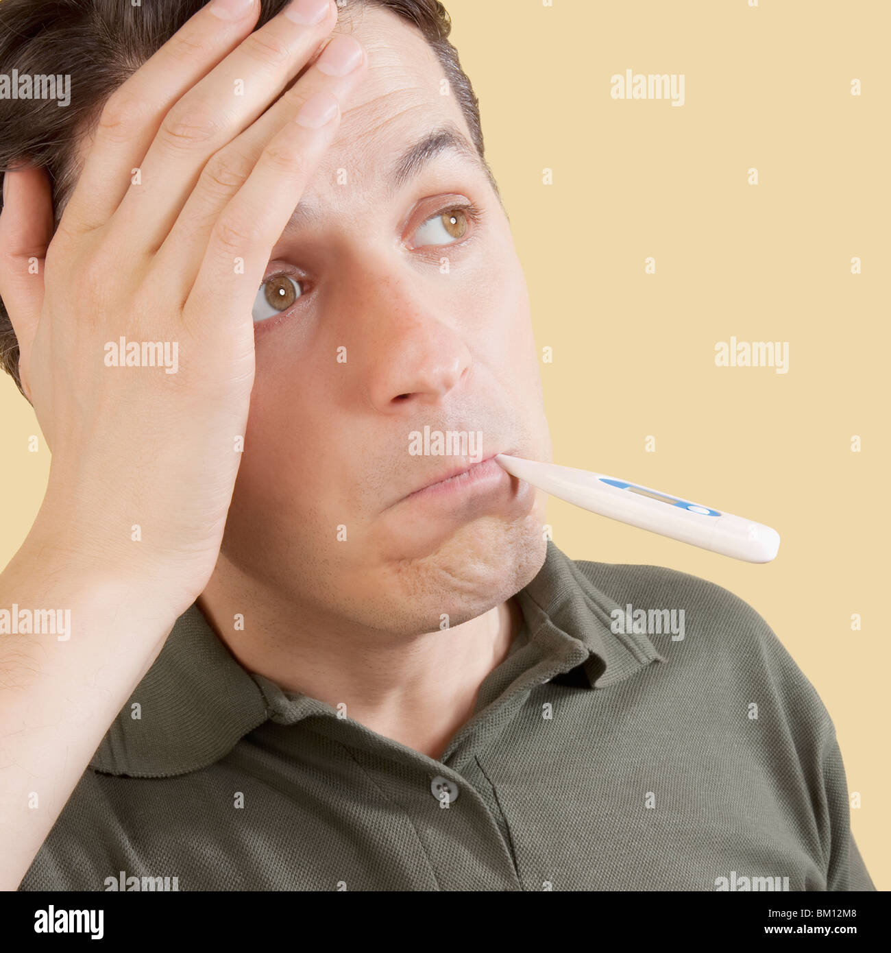 Man checking his temperature with a thermometer Stock Photo - Alamy