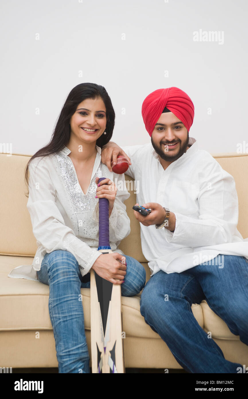 Sikh couple watching television Stock Photo - Alamy