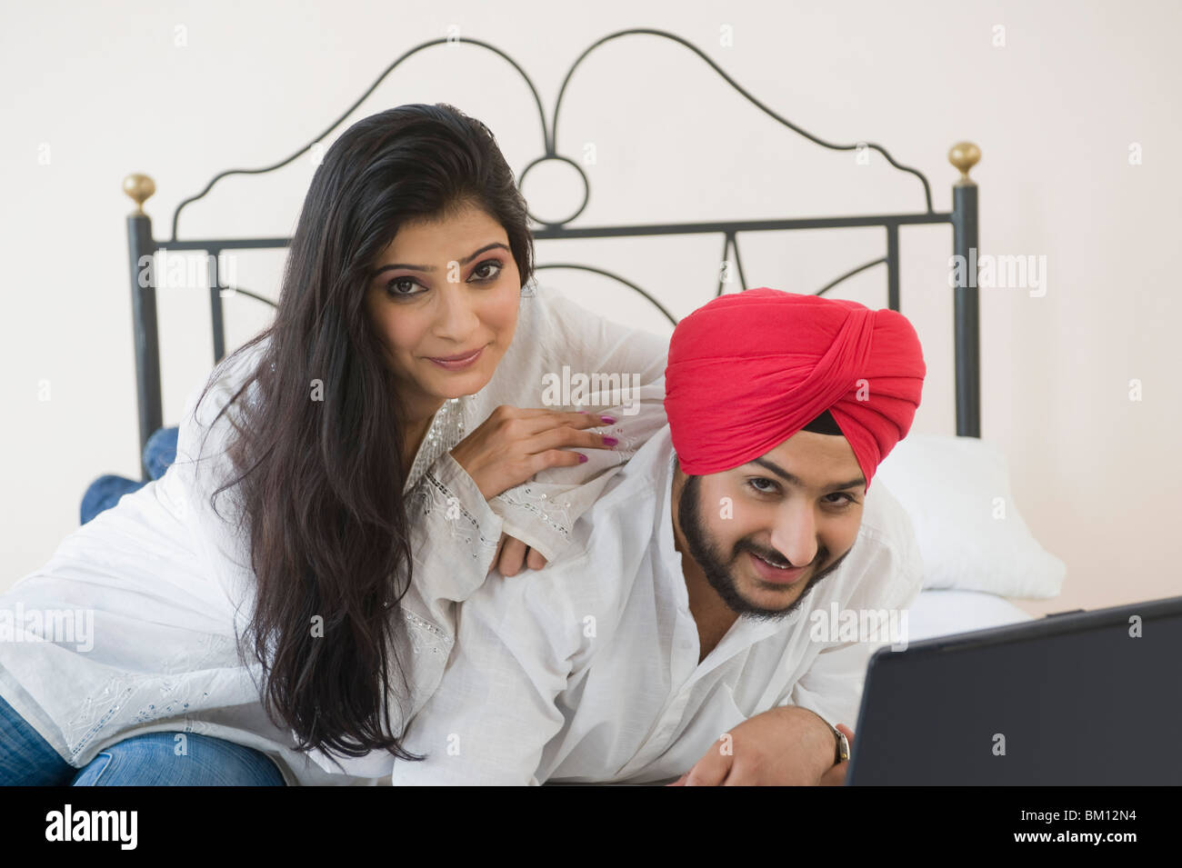 Indian couple lying in bed hi-res stock photography and images - Alamy