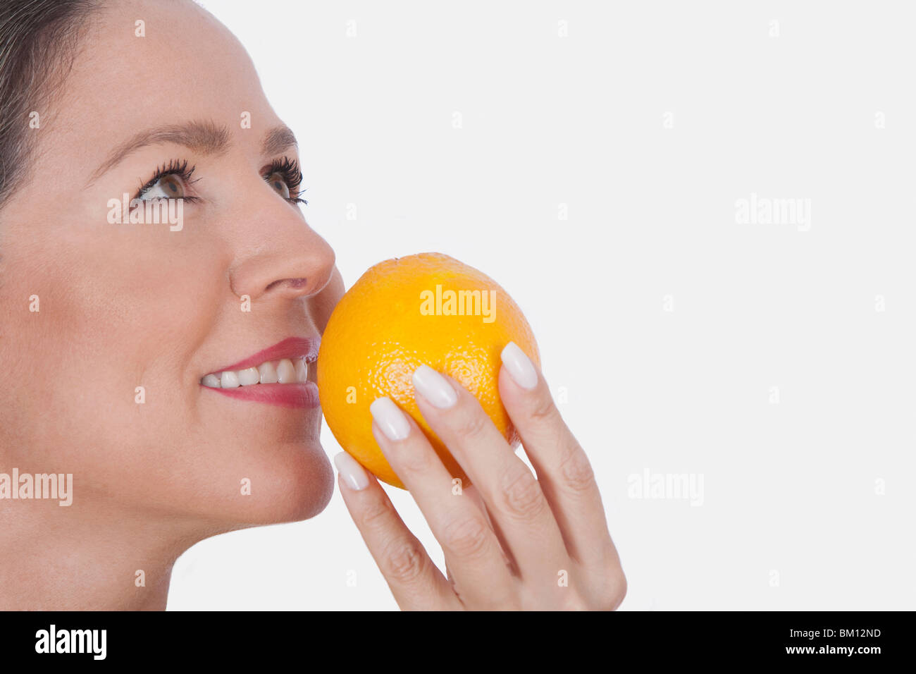 Woman smelling orange fruit hi-res stock photography and images - Alamy