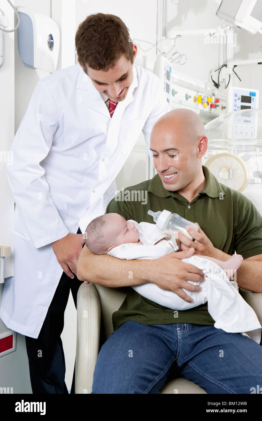 Man carrying his newborn baby Stock Photo - Alamy