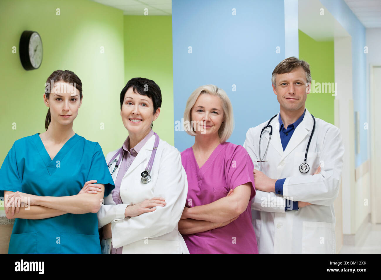 Two doctors standing with two nurses and smiling Stock Photo - Alamy