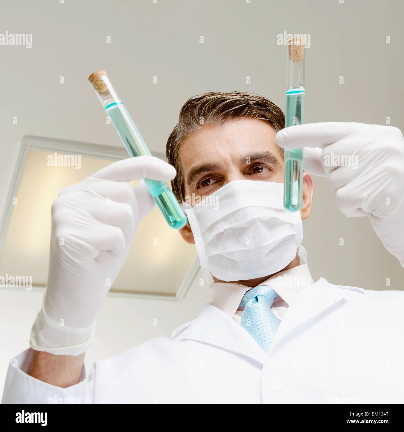 Lab technician analyzing sample in test tubes Stock Photo - Alamy