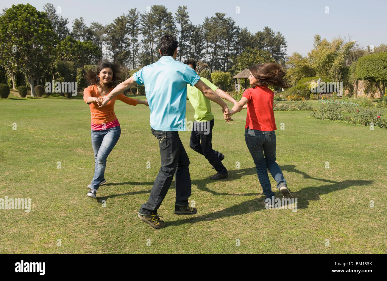 Friends playing in a park Stock Photo - Alamy