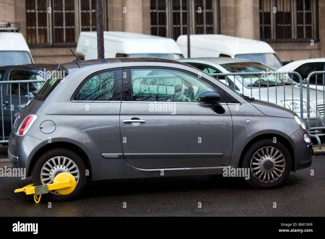 street cuff on a wheel of wrong parking silver car Stock Photo - Alamy