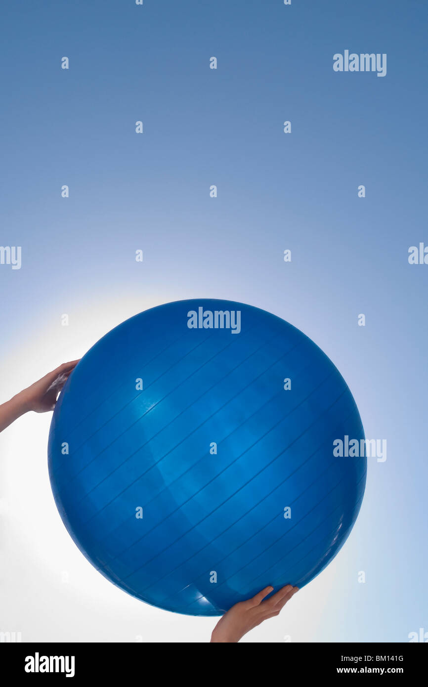 Person's hands holding a fitness ball Stock Photo - Alamy