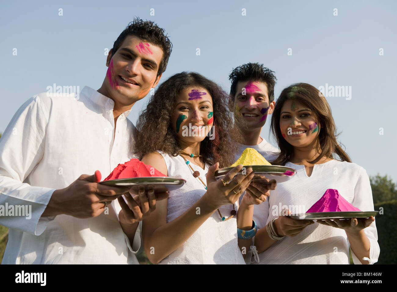 Friends celebrating Holi Stock Photo - Alamy