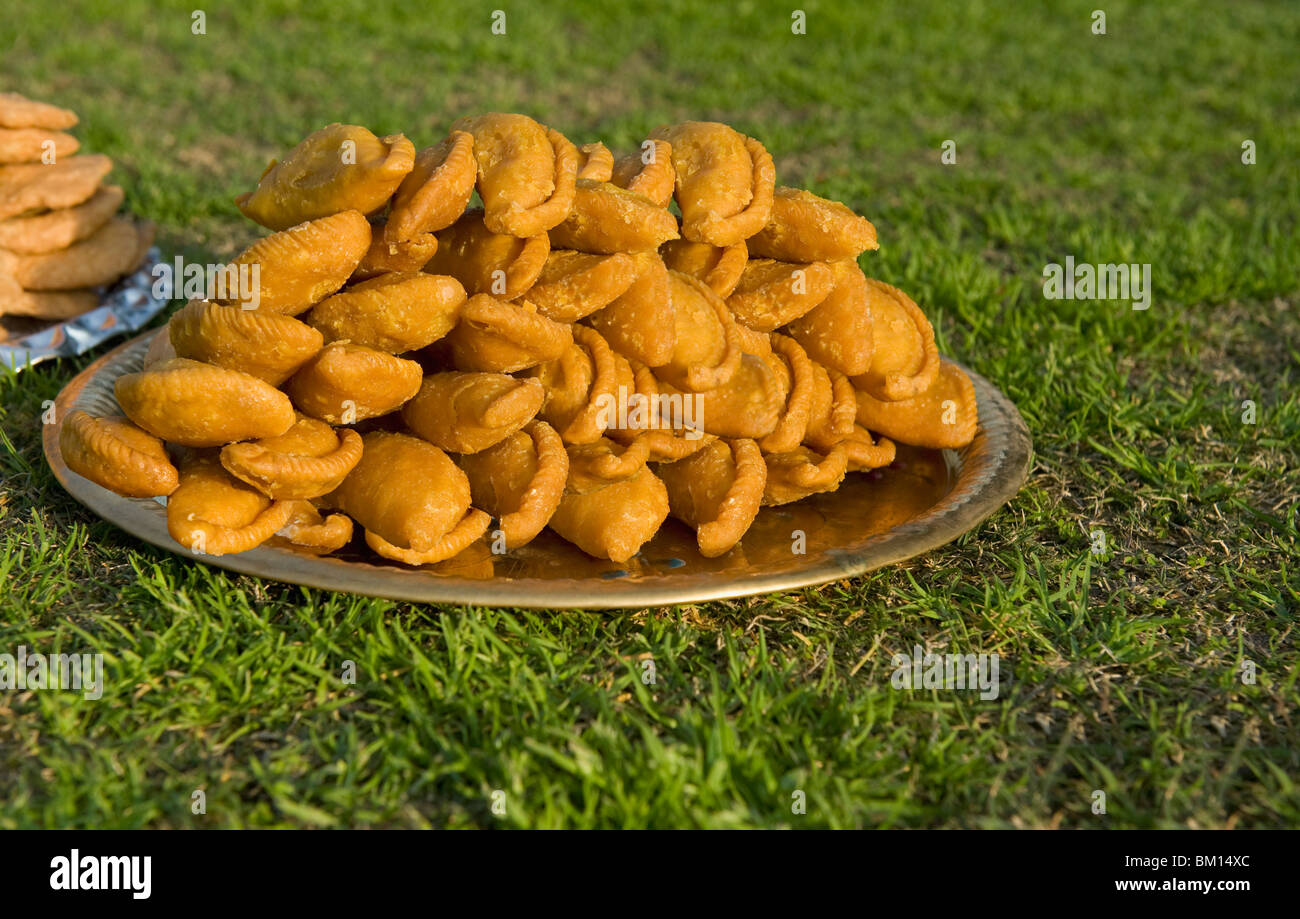Plates of gujiyas in a lawn Stock Photo - Alamy