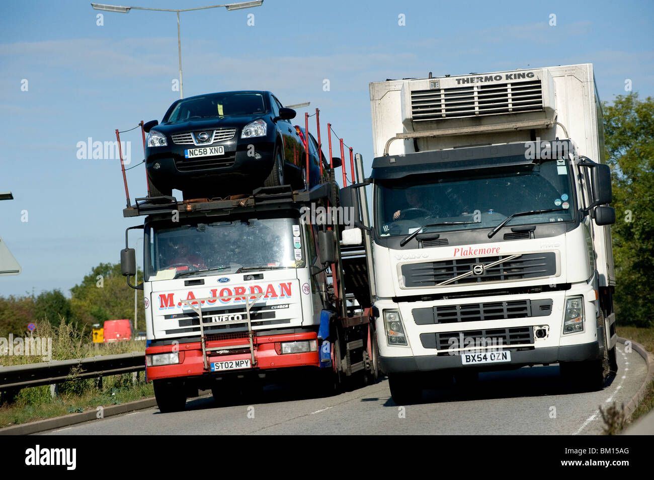 Car transporter overtaking a lorry on a busy dual carriageway in ...