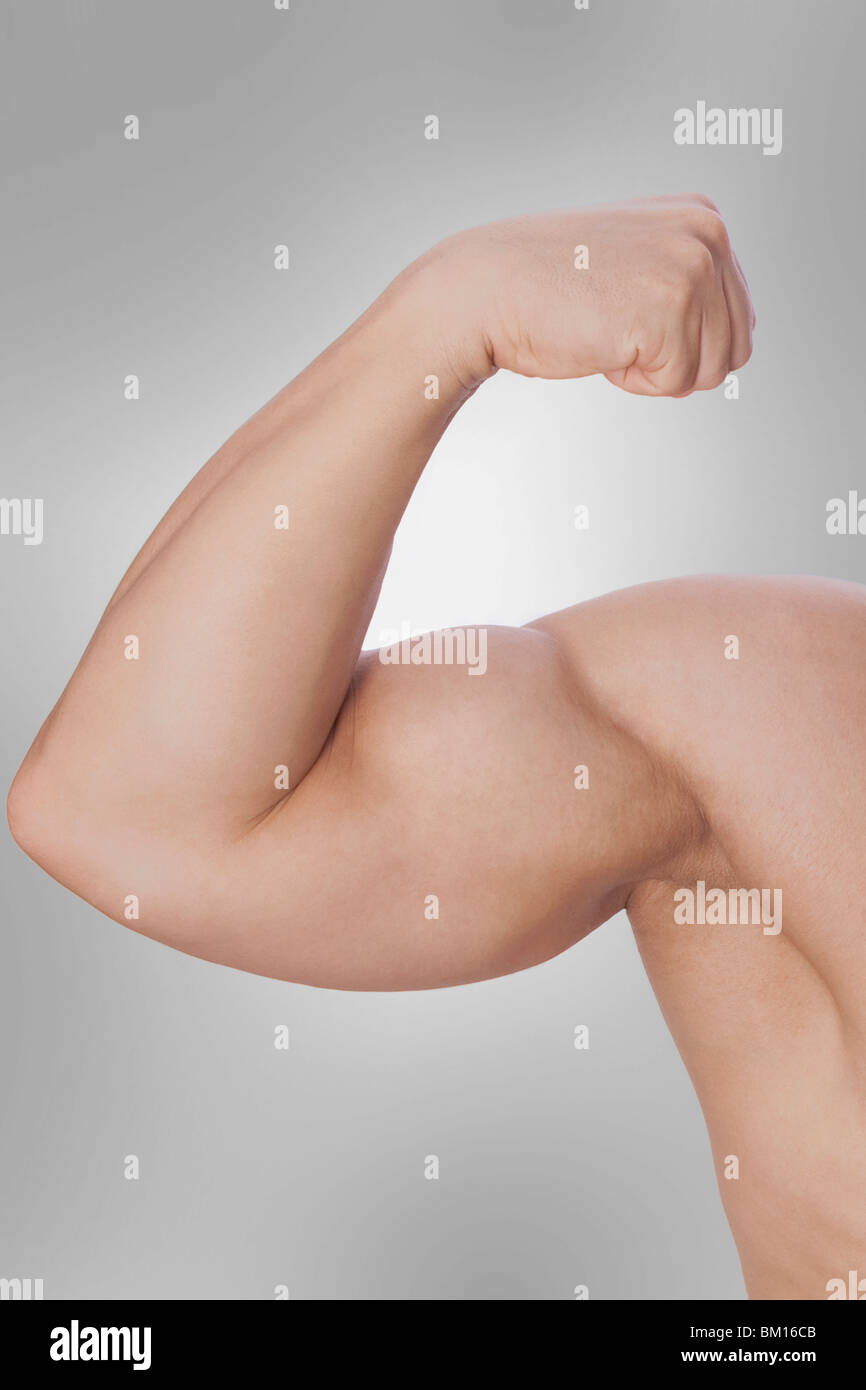 Close-up of a man showing biceps Stock Photo - Alamy
