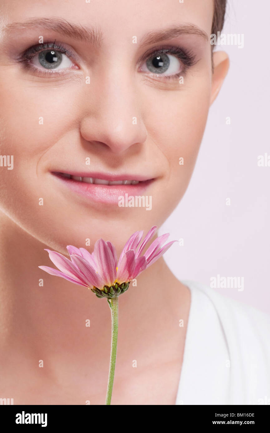Portrait of a woman smelling a flower Stock Photo - Alamy