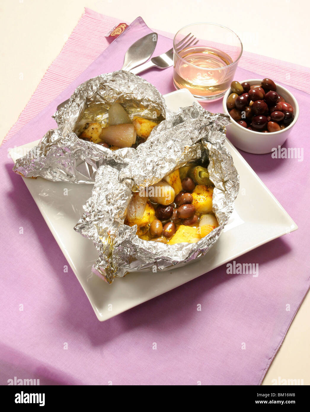 Cartoccio di pescatrice, fish with olives and vegetable baked in foil ...