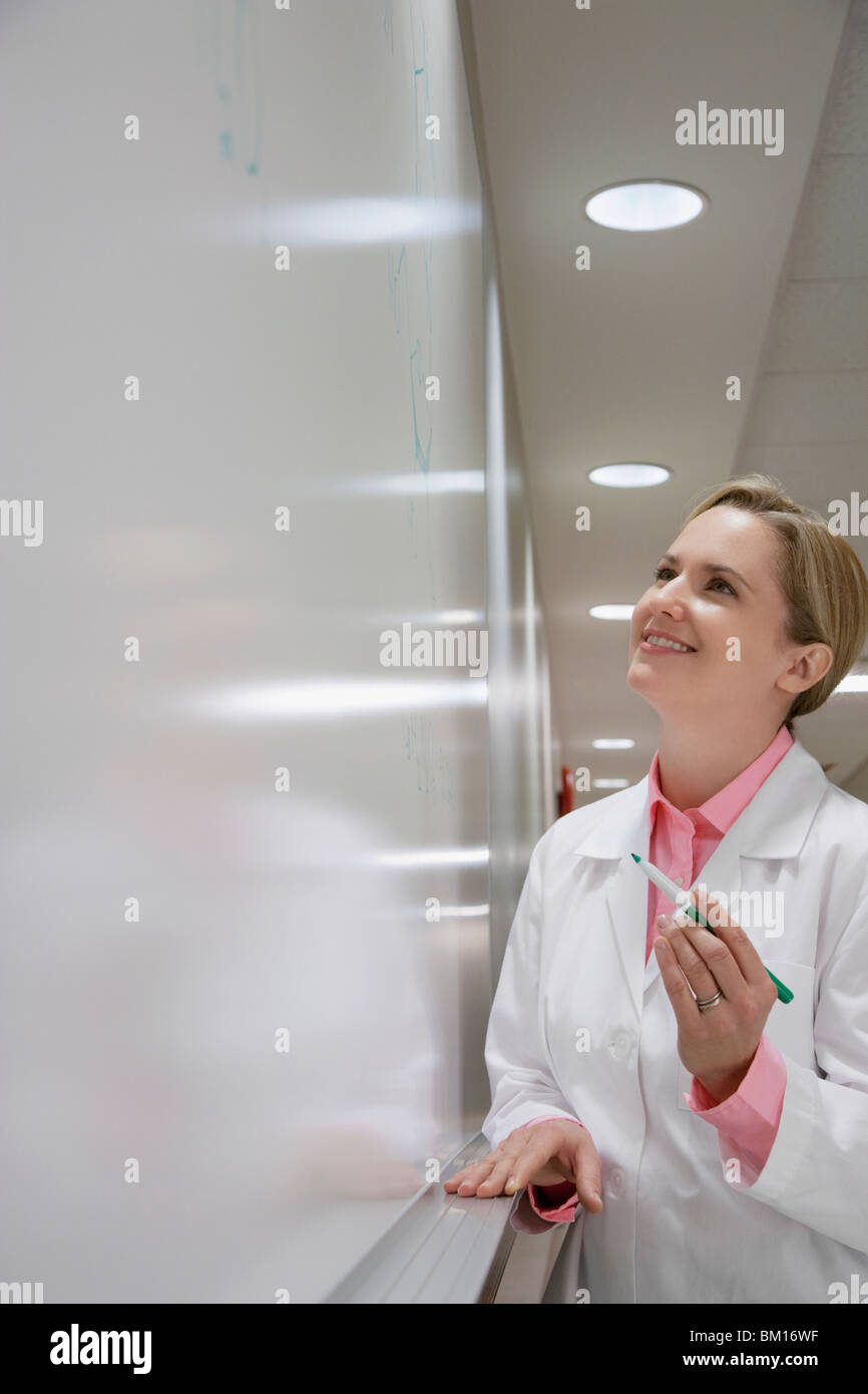 Female doctor writing on a whiteboard in a hospital Stock Photo - Alamy