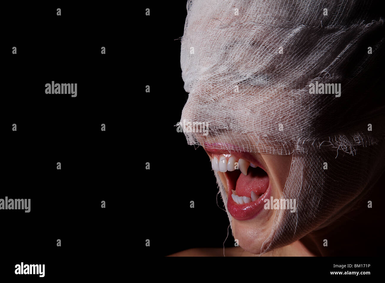 Girl's face wound with bandage with a teeth as at the vampire on a ...