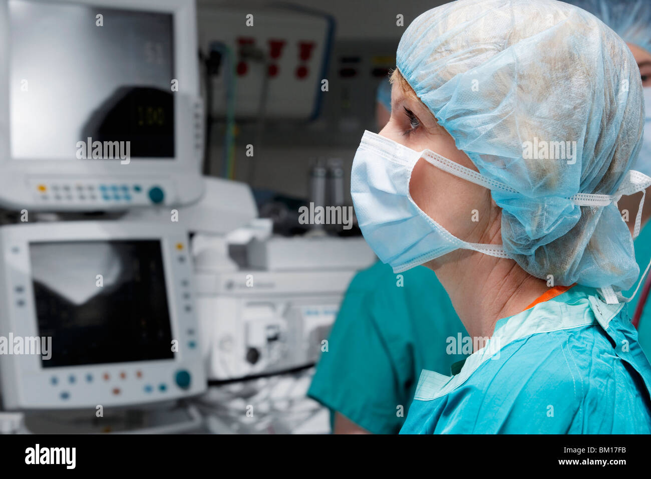 Female doctor working on a cardiac monitor Stock Photo - Alamy