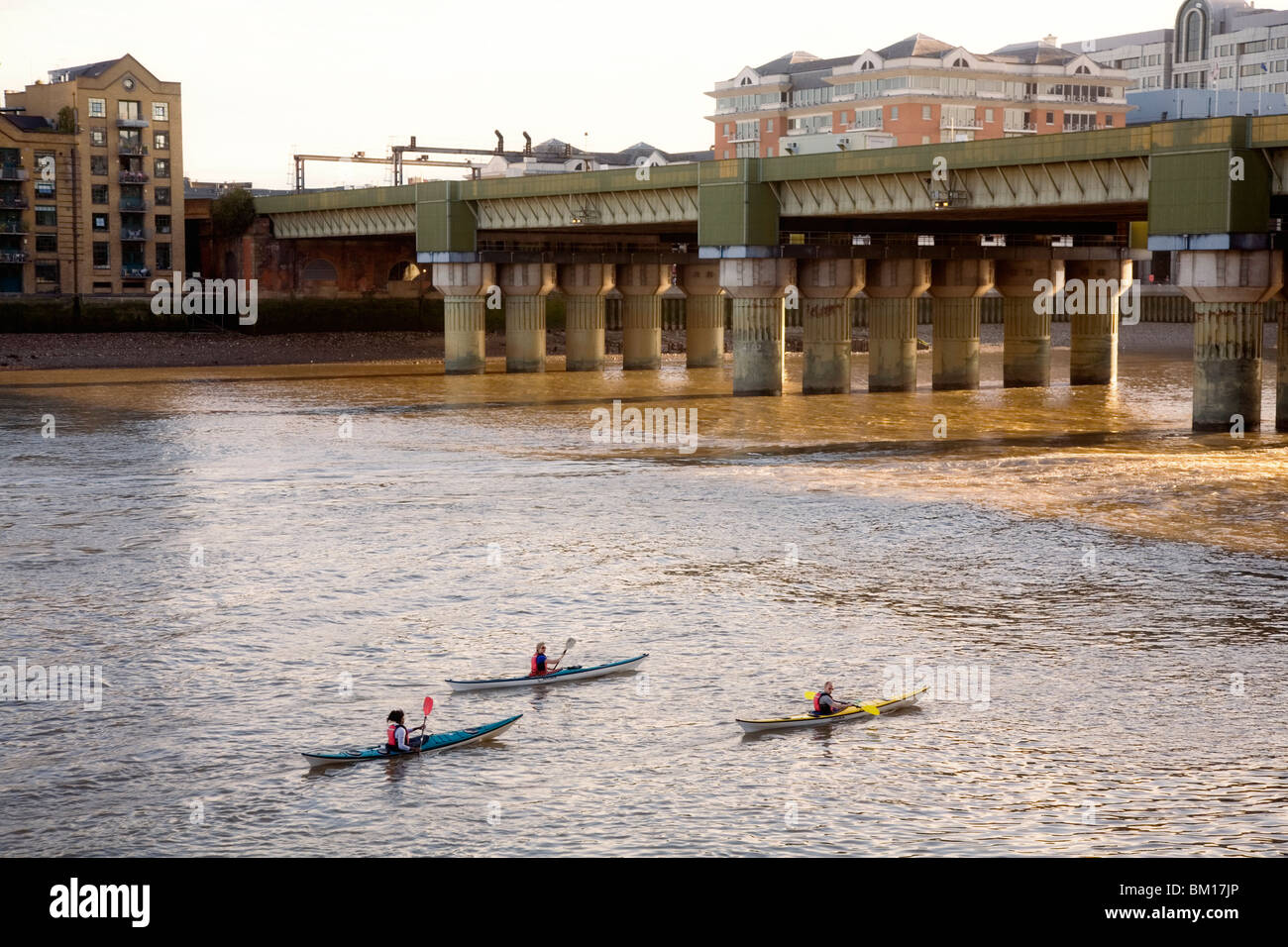 Three kayakers paddling together hi-res stock photography and images ...