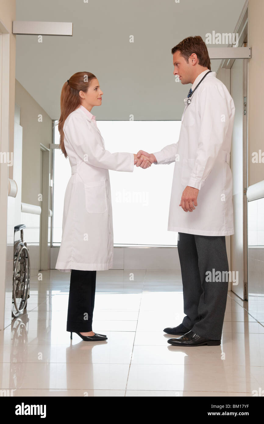 Two doctors shaking hands in a hospital corridor Stock Photo - Alamy