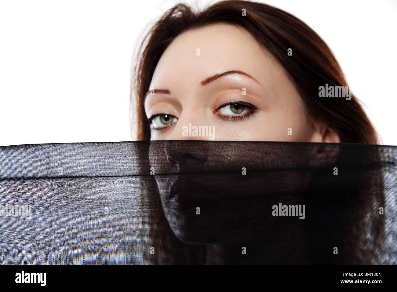 Model half of the face covered with a black transparent fabric, a ...