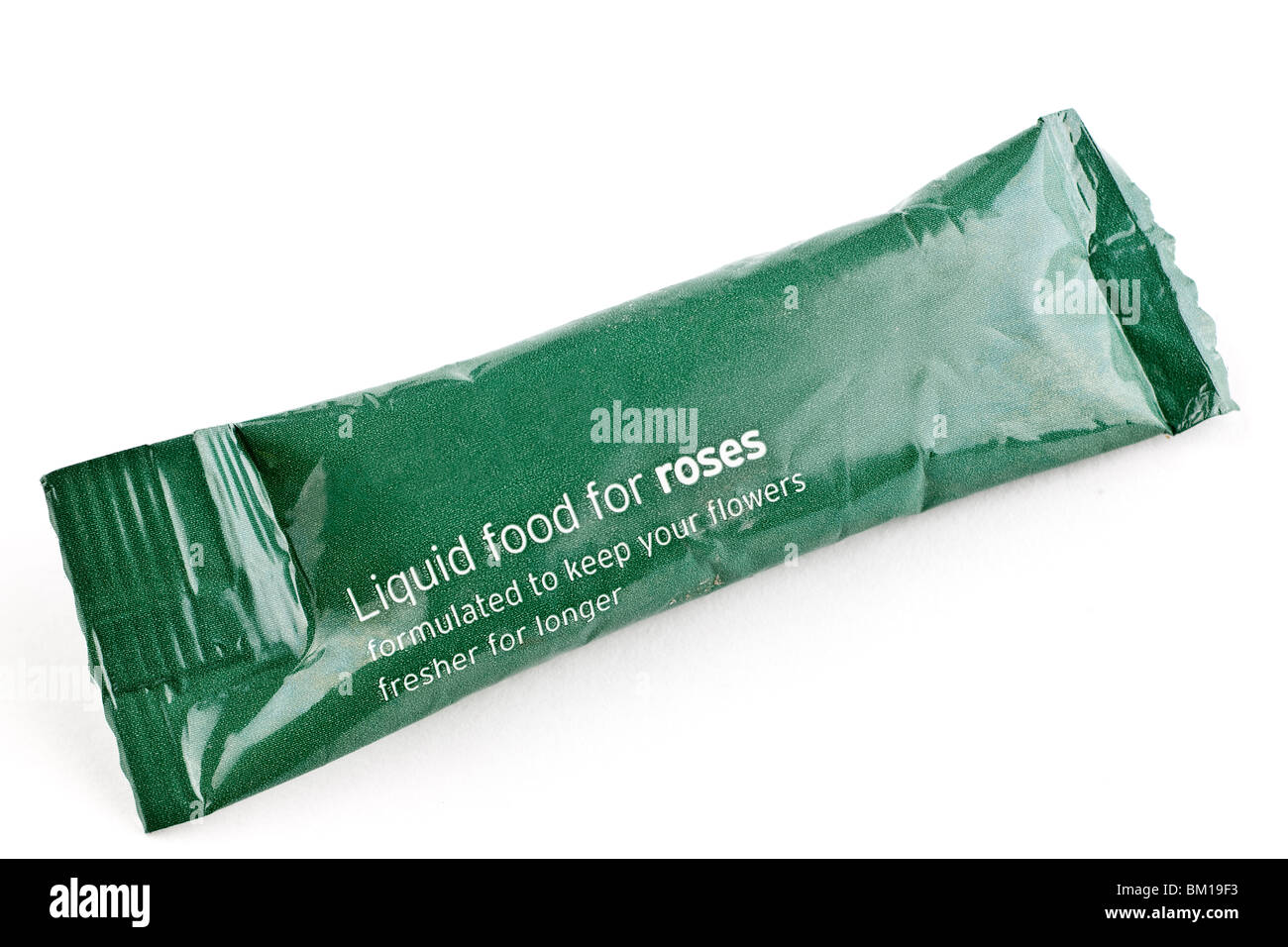 Small green sachet of liquid food for roses Stock Photo - Alamy
