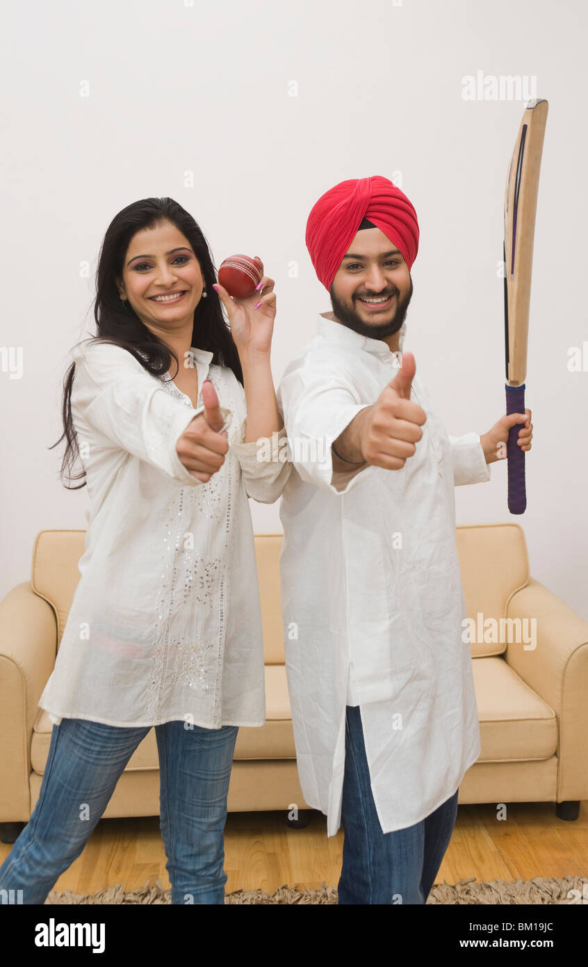 Sikh couple with cricket bat and a ball Stock Photo - Alamy
