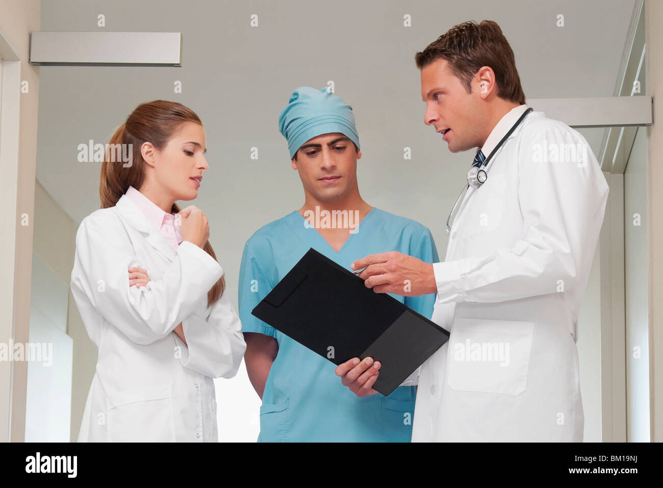 Three doctors discussing in a hospital Stock Photo - Alamy