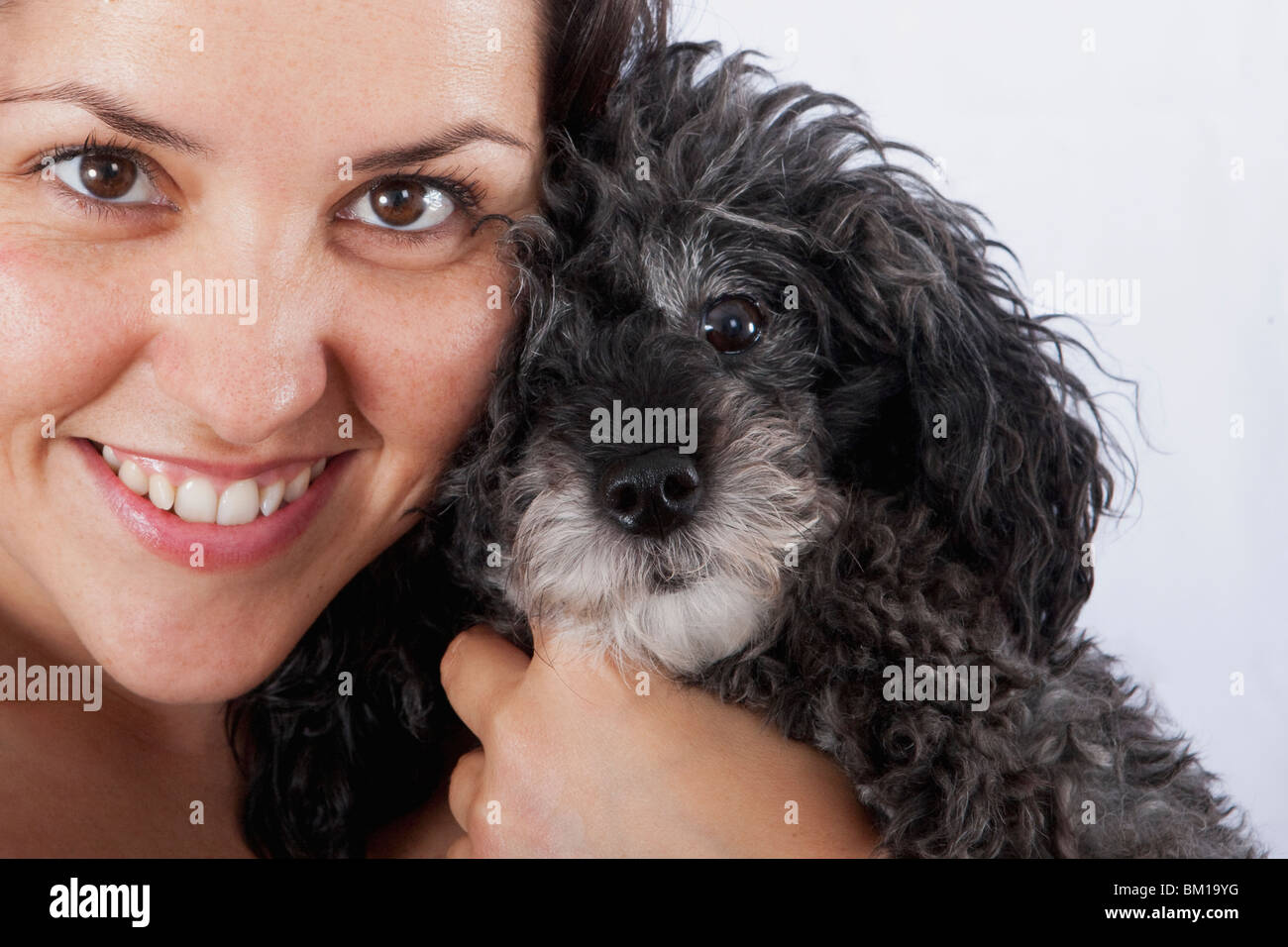 Portrait of a woman hugging a Poodle and smiling Stock Photo - Alamy