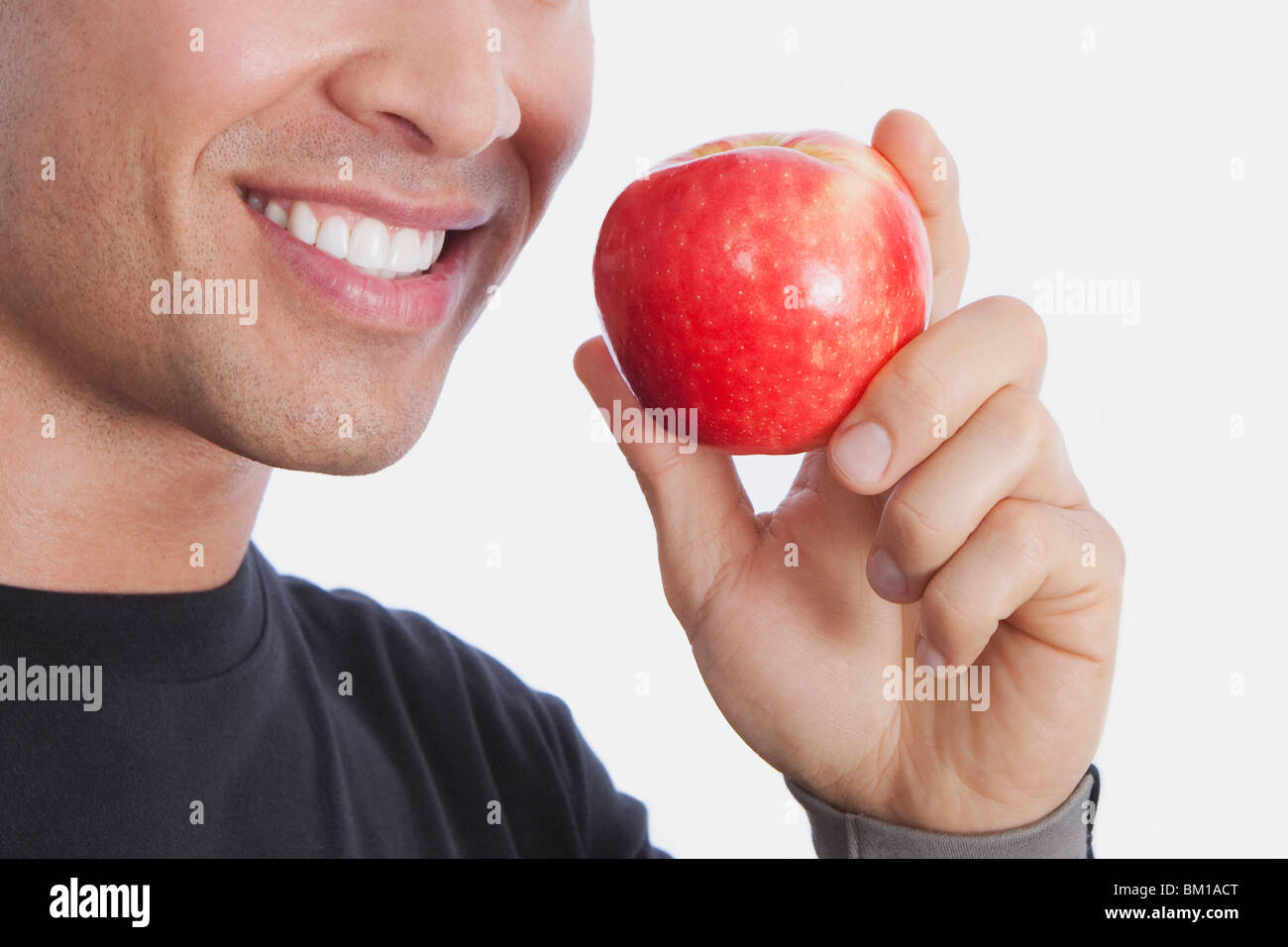Man holding an apple Stock Photo - Alamy