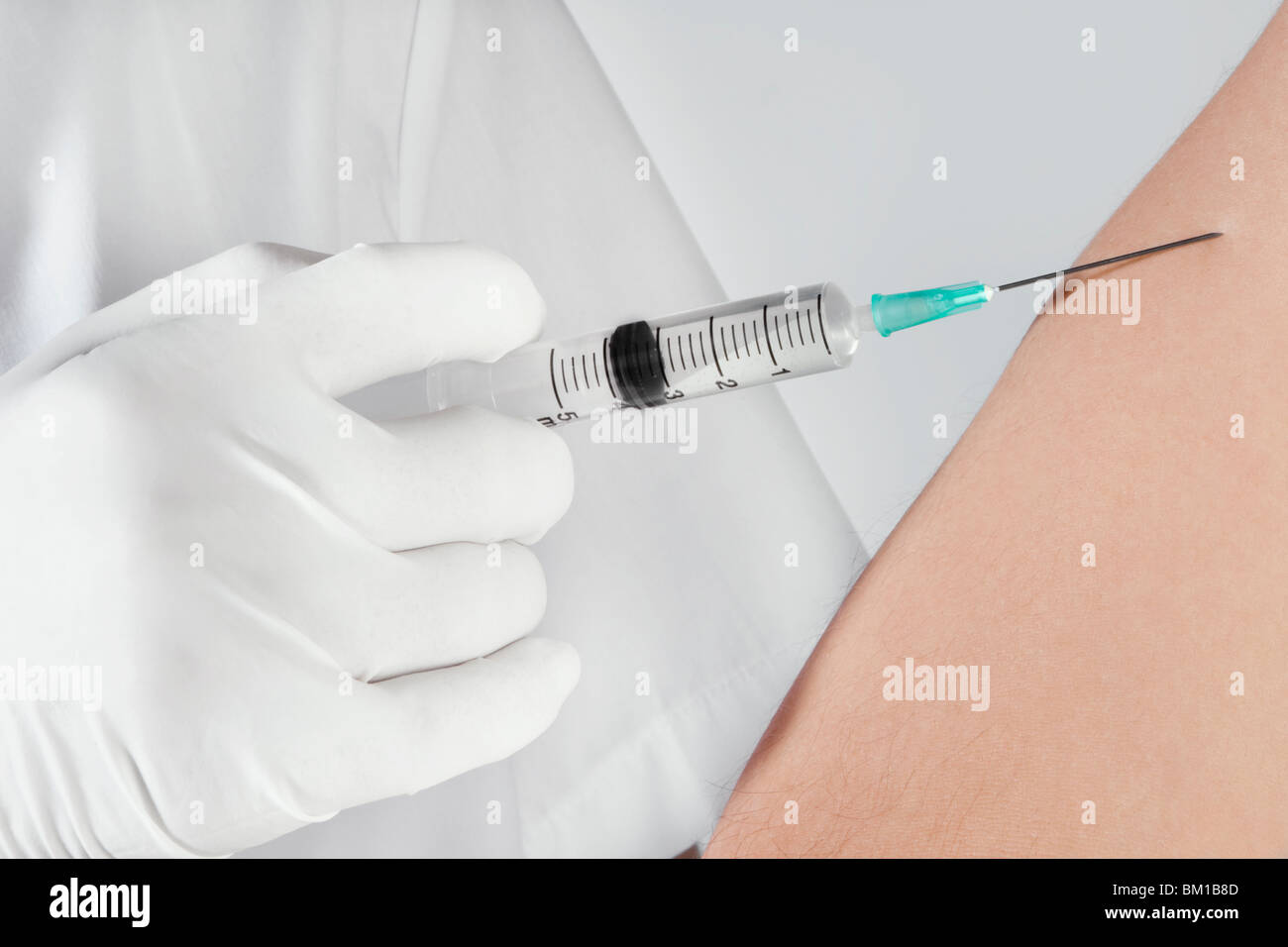 Doctor giving injection to a patient Stock Photo - Alamy