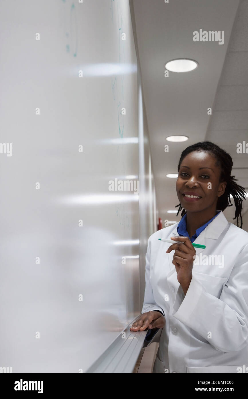 Female doctor writing on a whiteboard in a hospital Stock Photo - Alamy