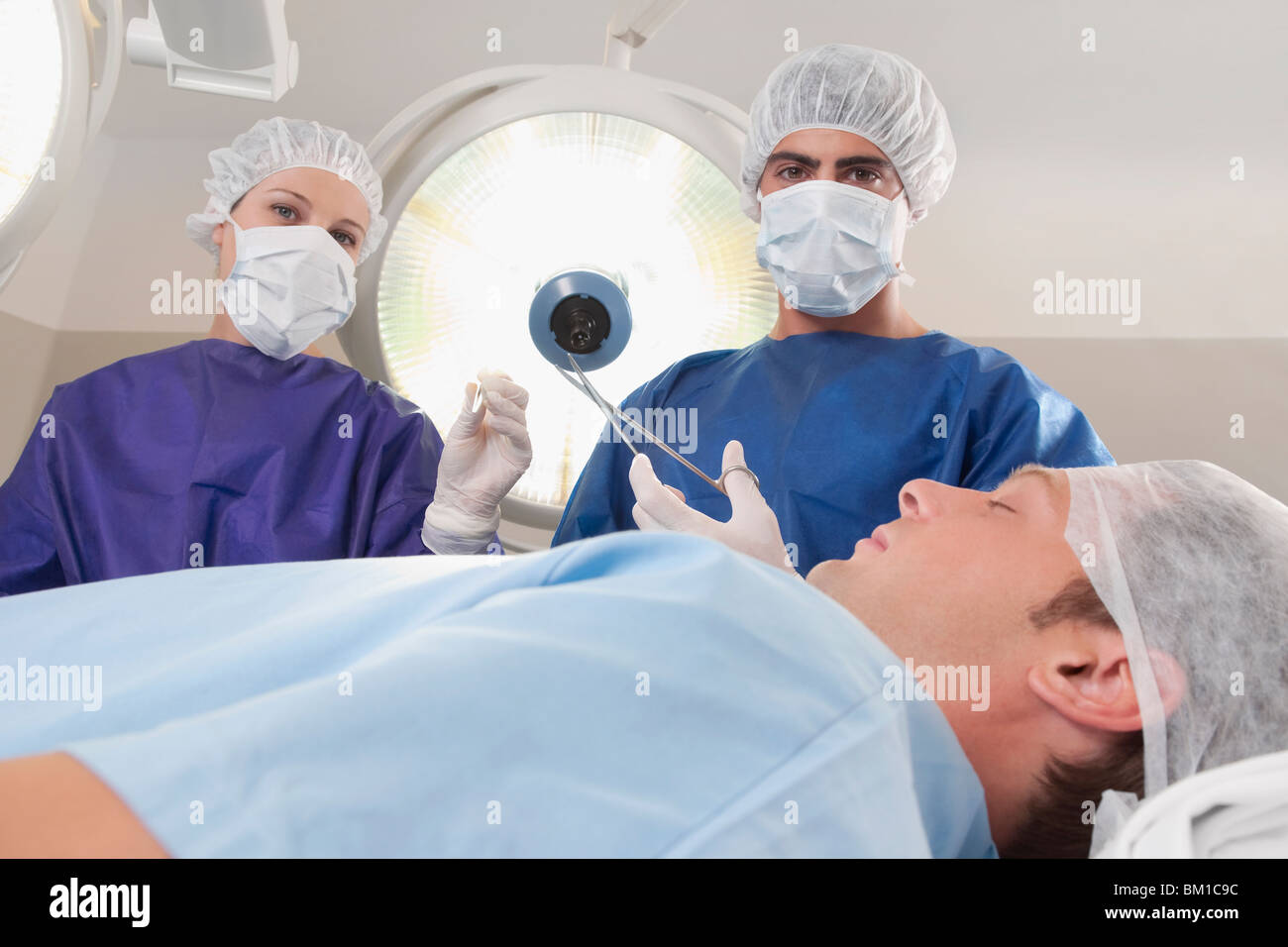 Two surgeons operating a patient in an operating room Stock Photo - Alamy